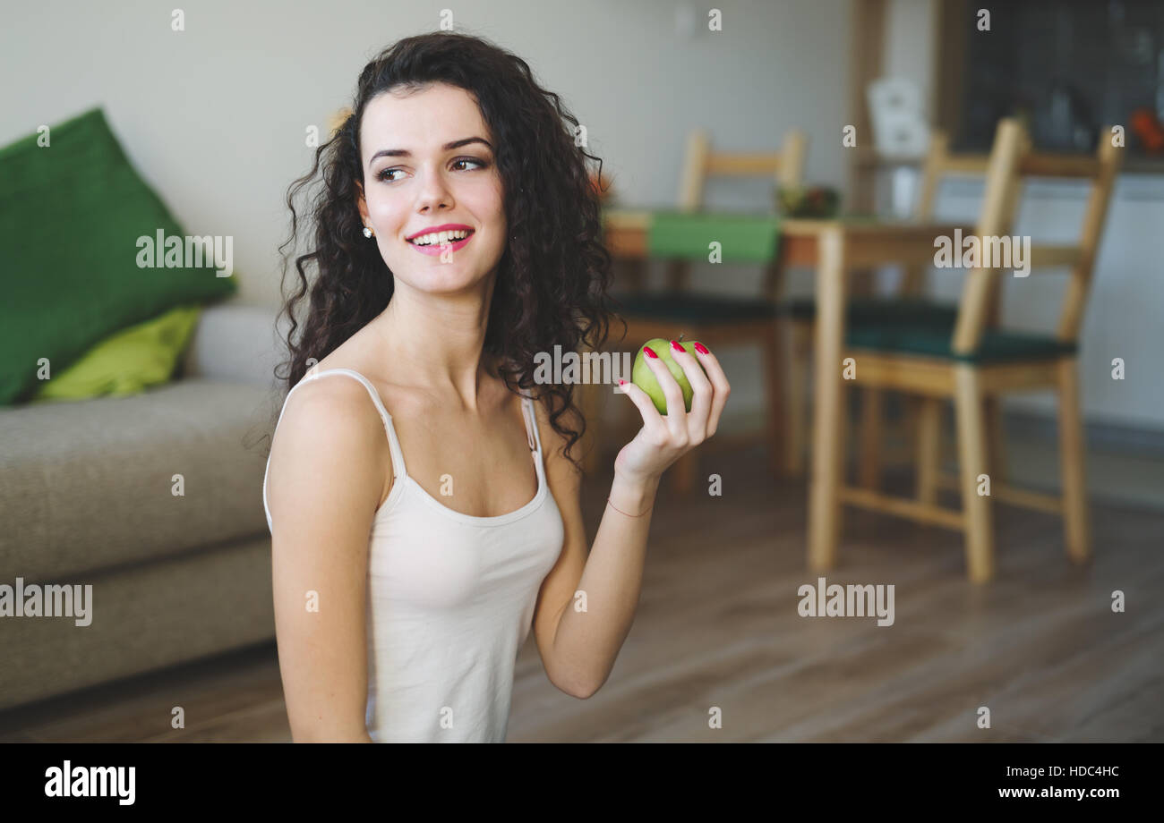 Sporty woman eating healthy apple after exercising Stock Photo - Alamy