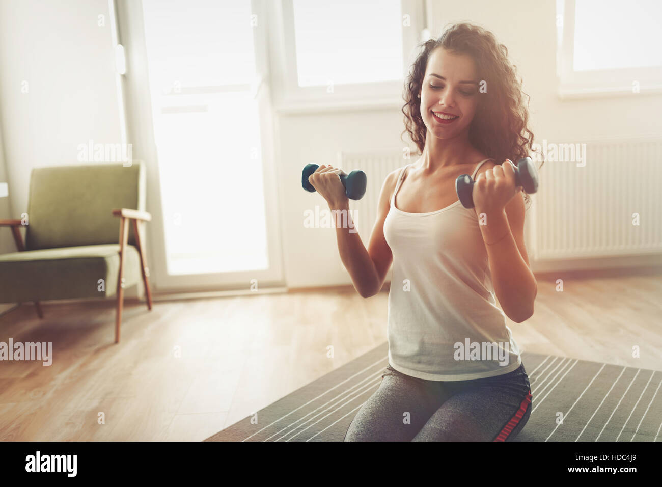 Sporty beautiful woman exercising at home to stay fit Stock Photo - Alamy