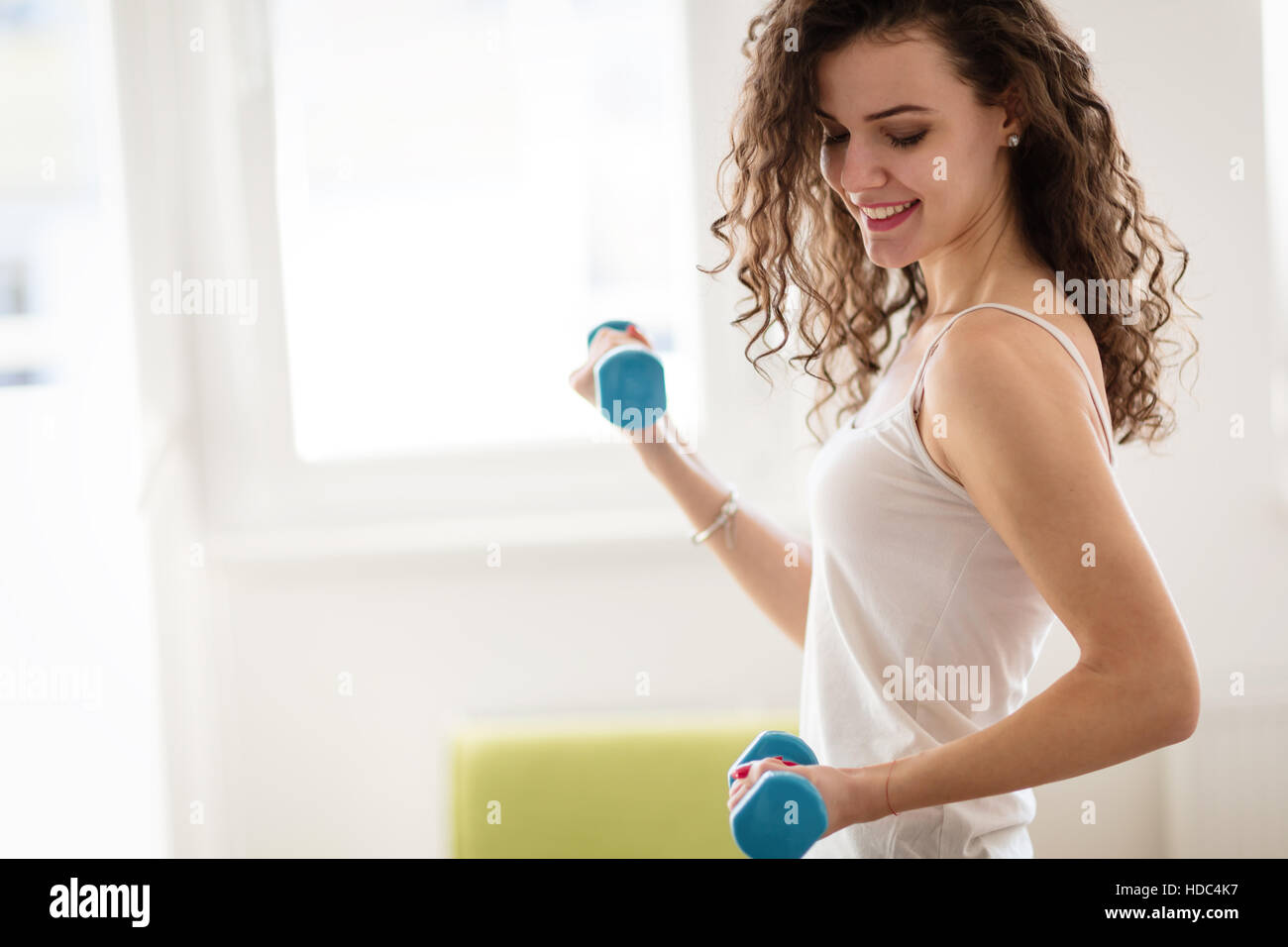 Sporty beautiful woman exercising at home to stay fit Stock Photo - Alamy