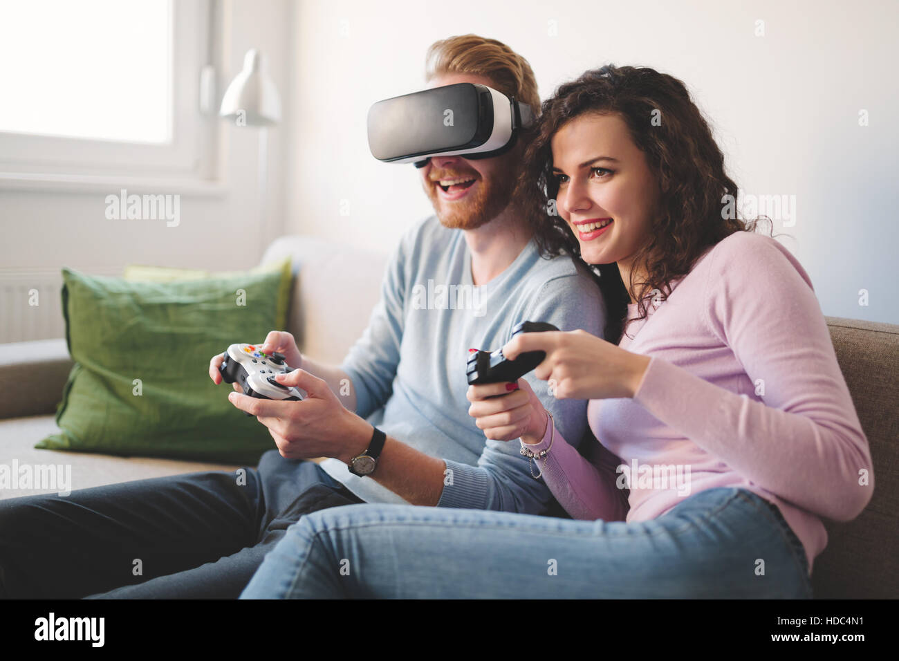 Couple having fun playing with virtual reality Stock Photo - Alamy