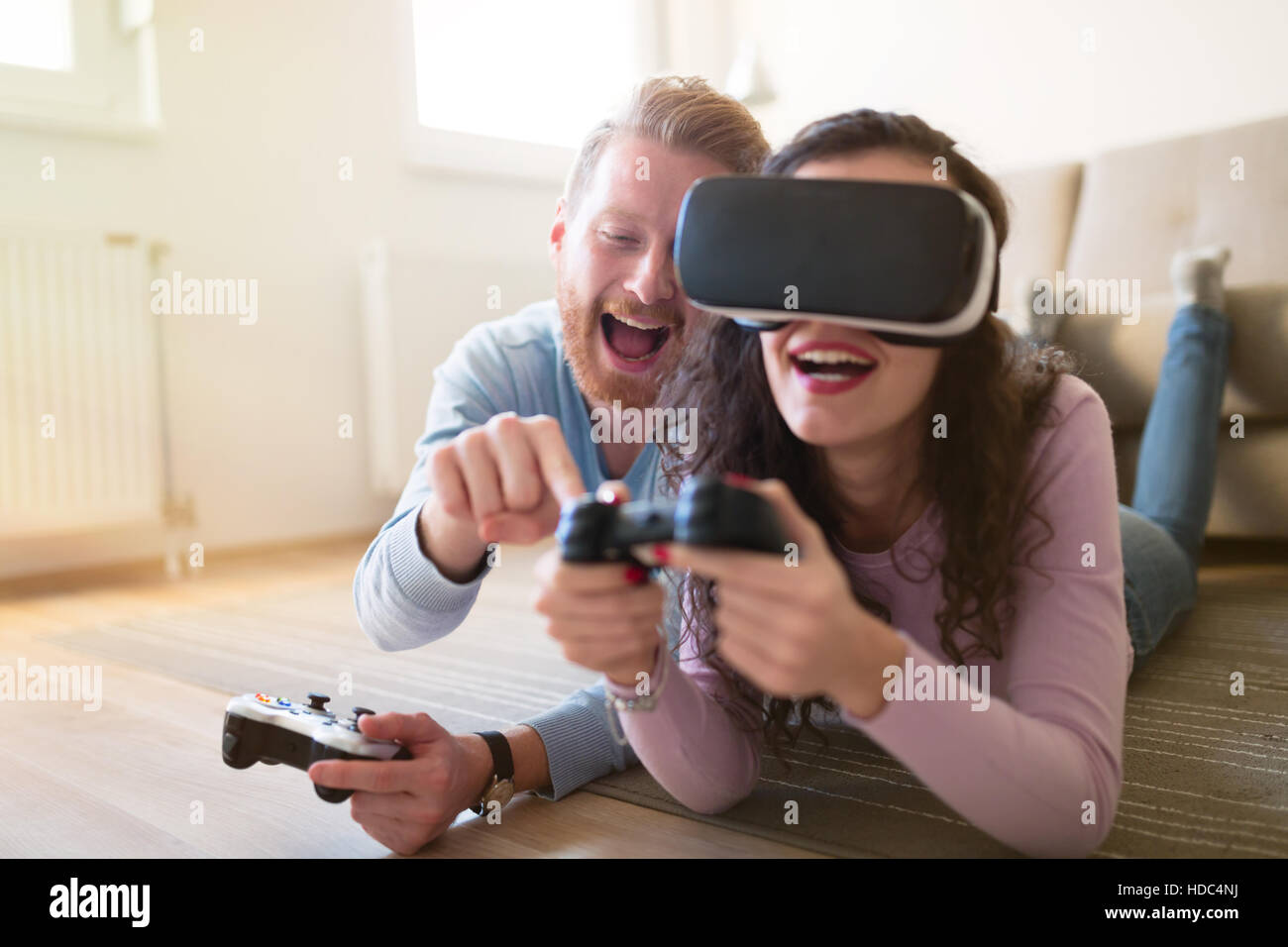 Couple having fun enjoying VR and playing games Stock Photo - Alamy