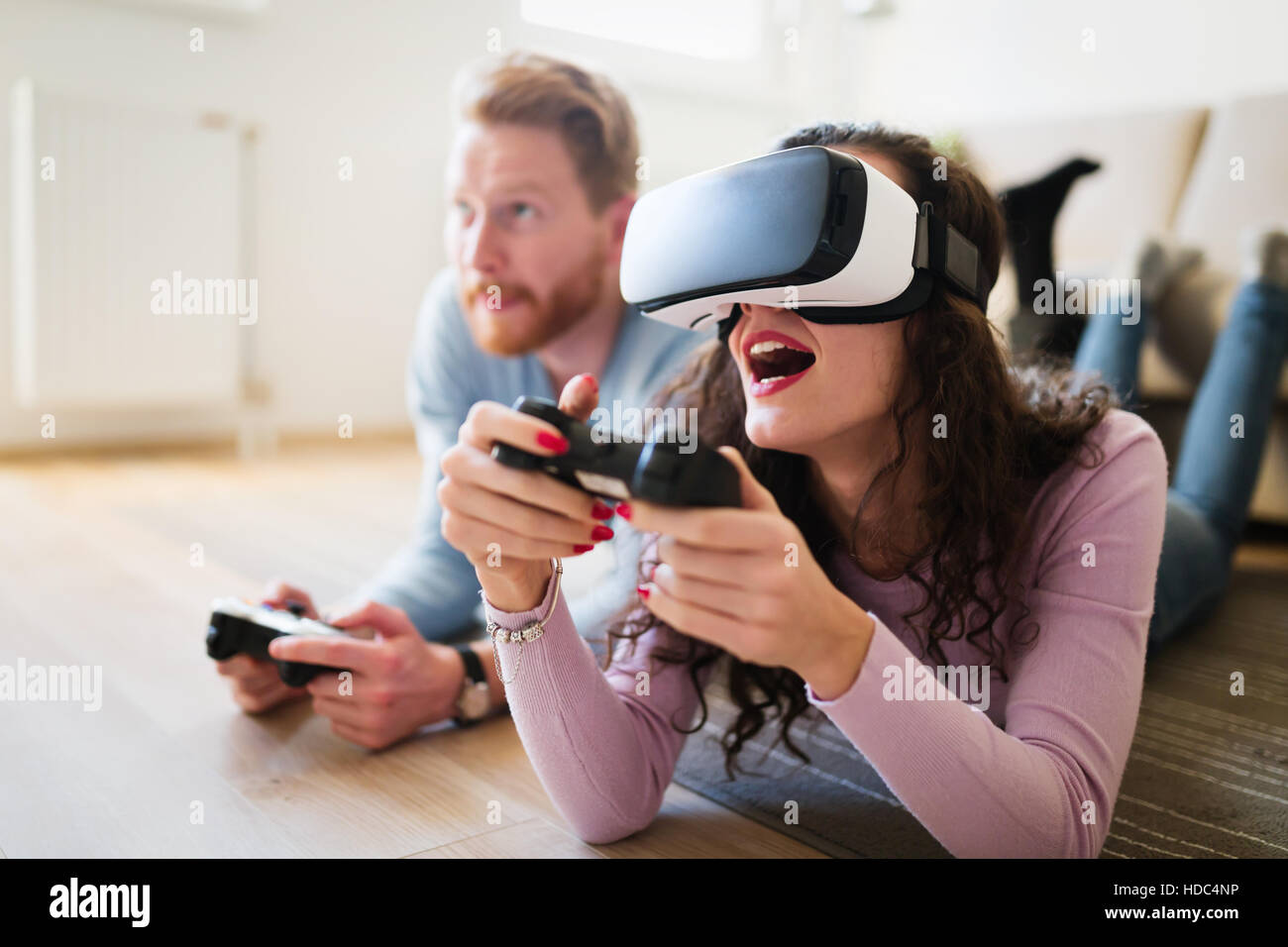 Couple having fun enjoying VR and playing games Stock Photo - Alamy