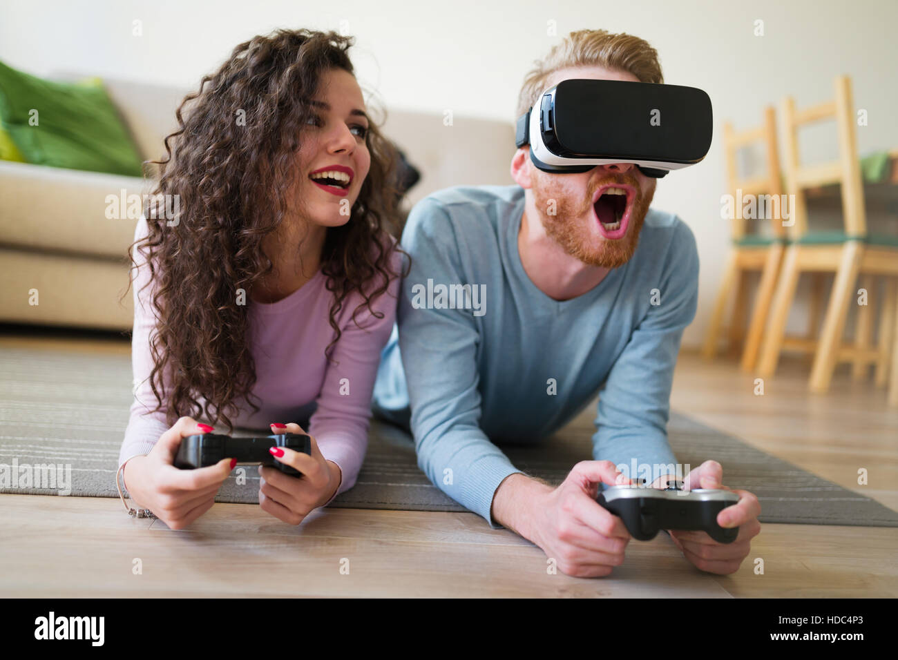 Couple having fun playing with virtual reality Stock Photo - Alamy