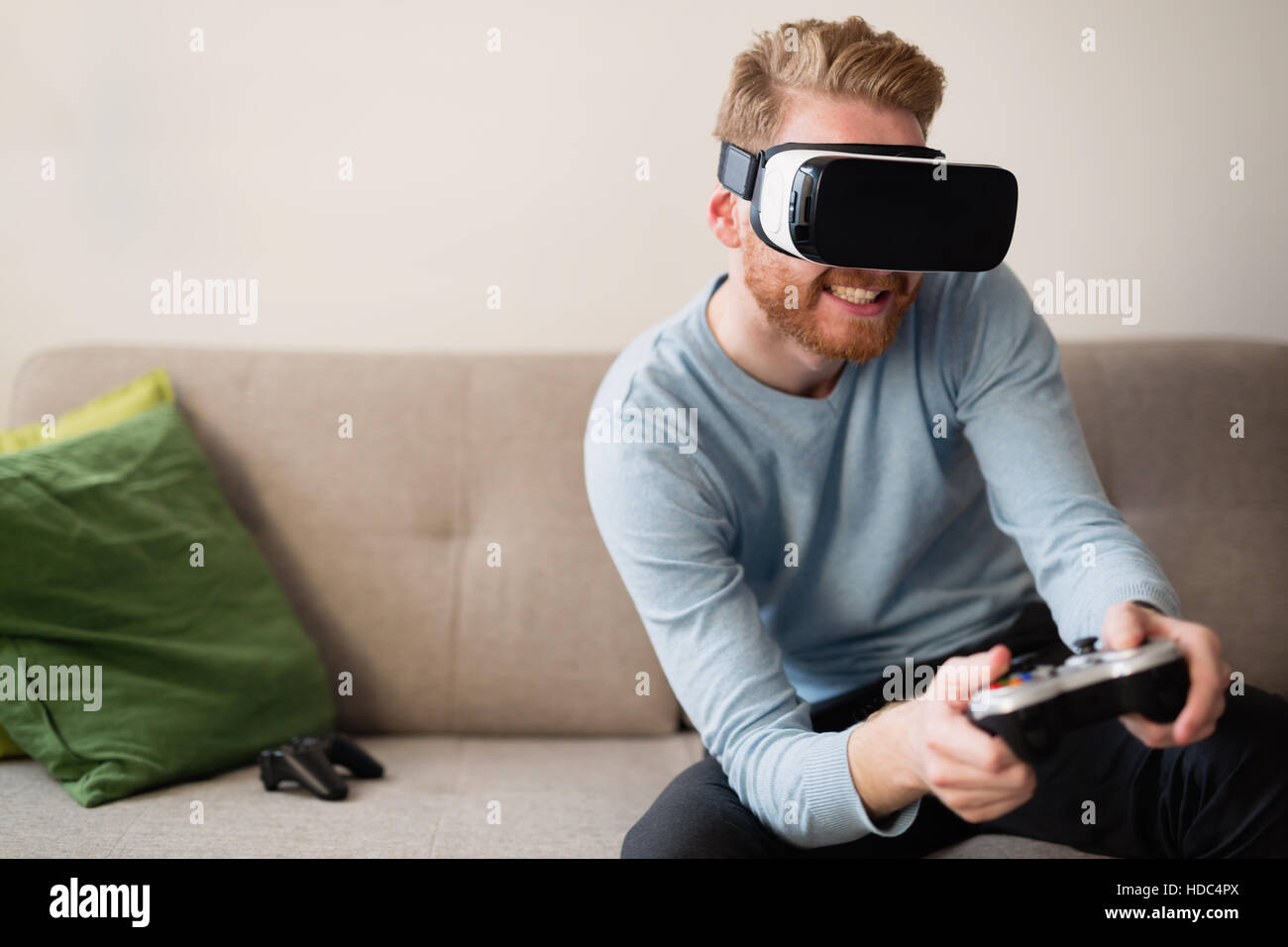 Smiling man enjoying vr simulation hi-res stock photography and images ...