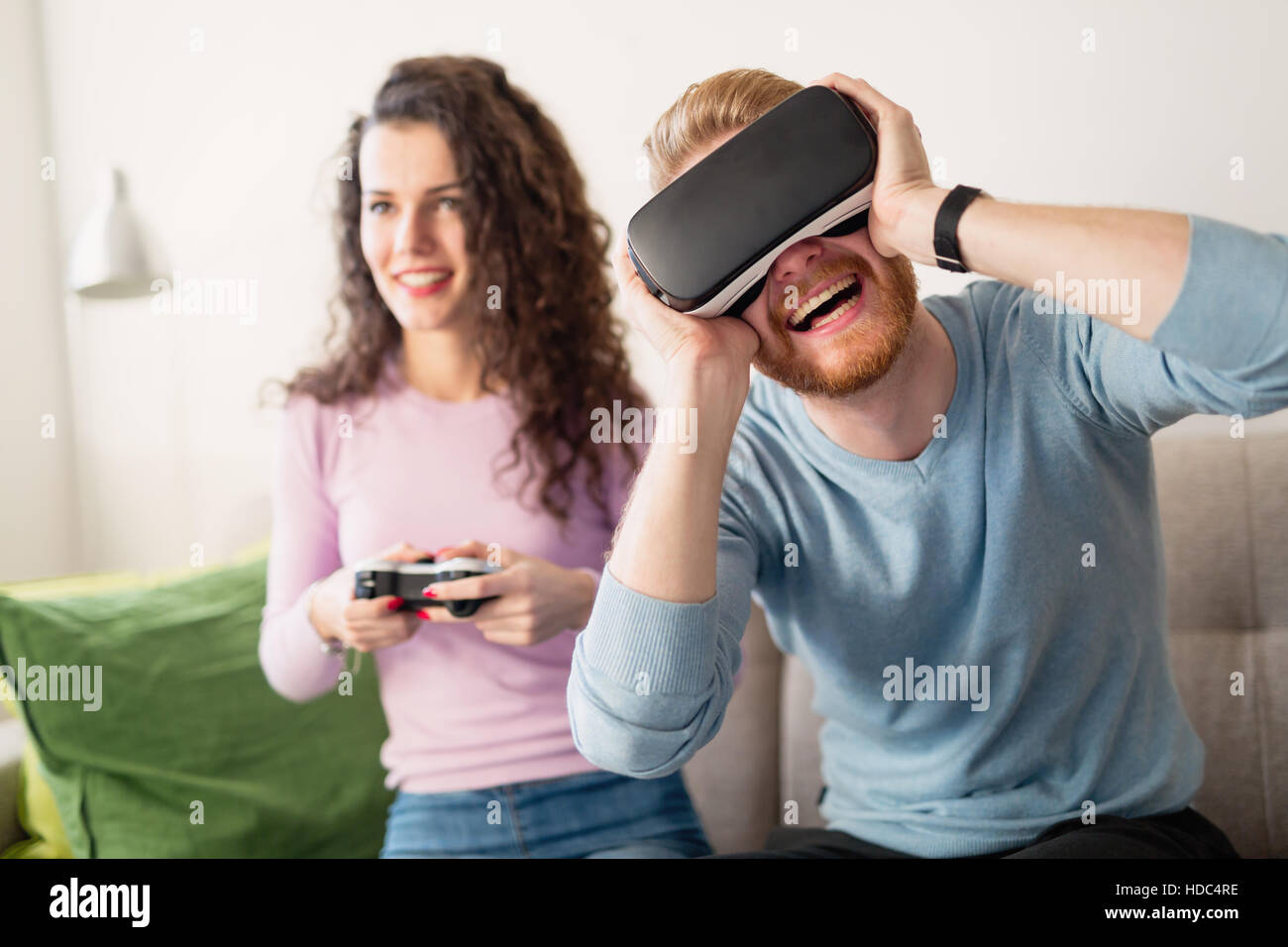 Couple having fun playing with virtual reality Stock Photo - Alamy