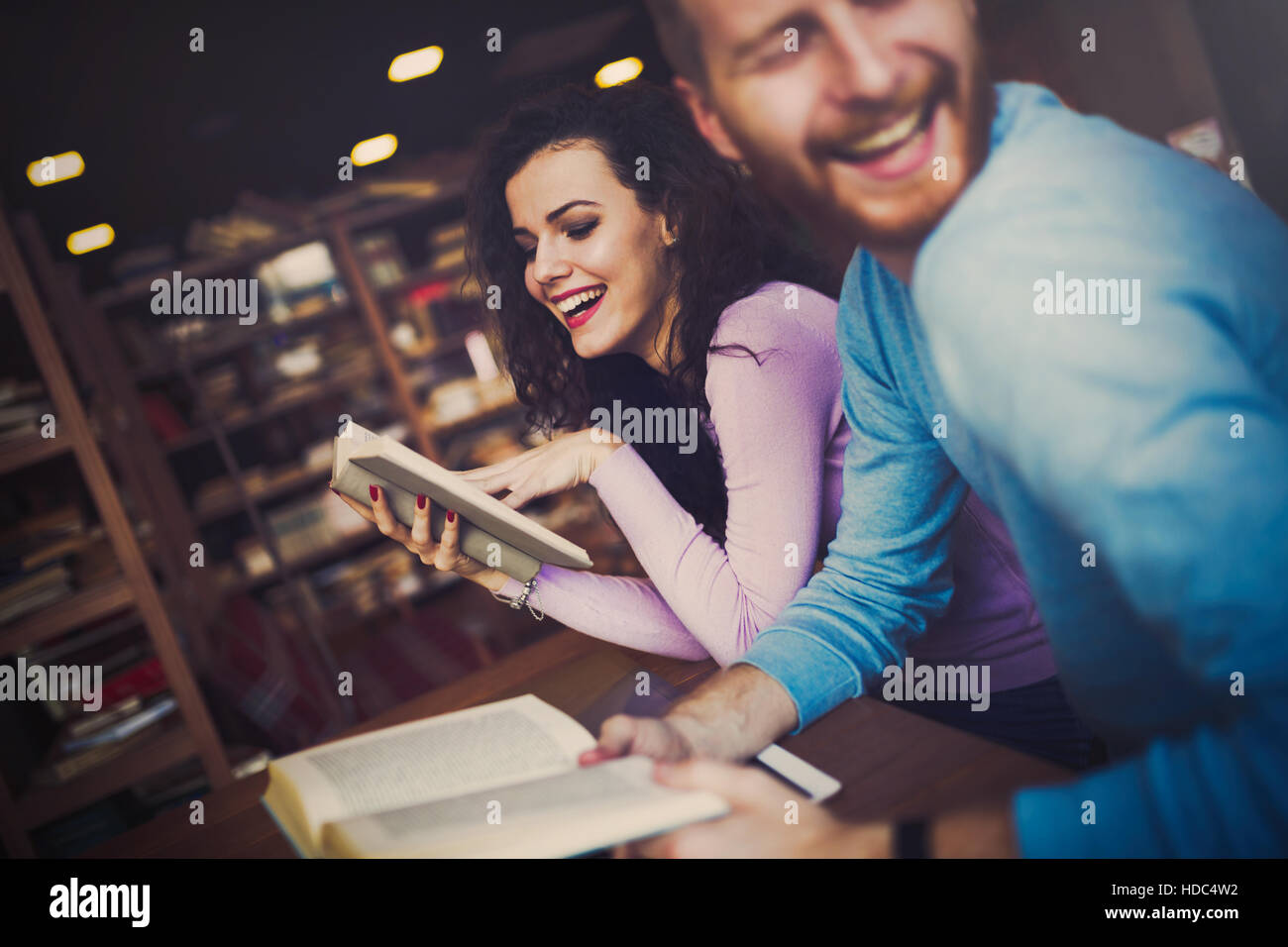 Young university students reading books and studying Stock Photo - Alamy