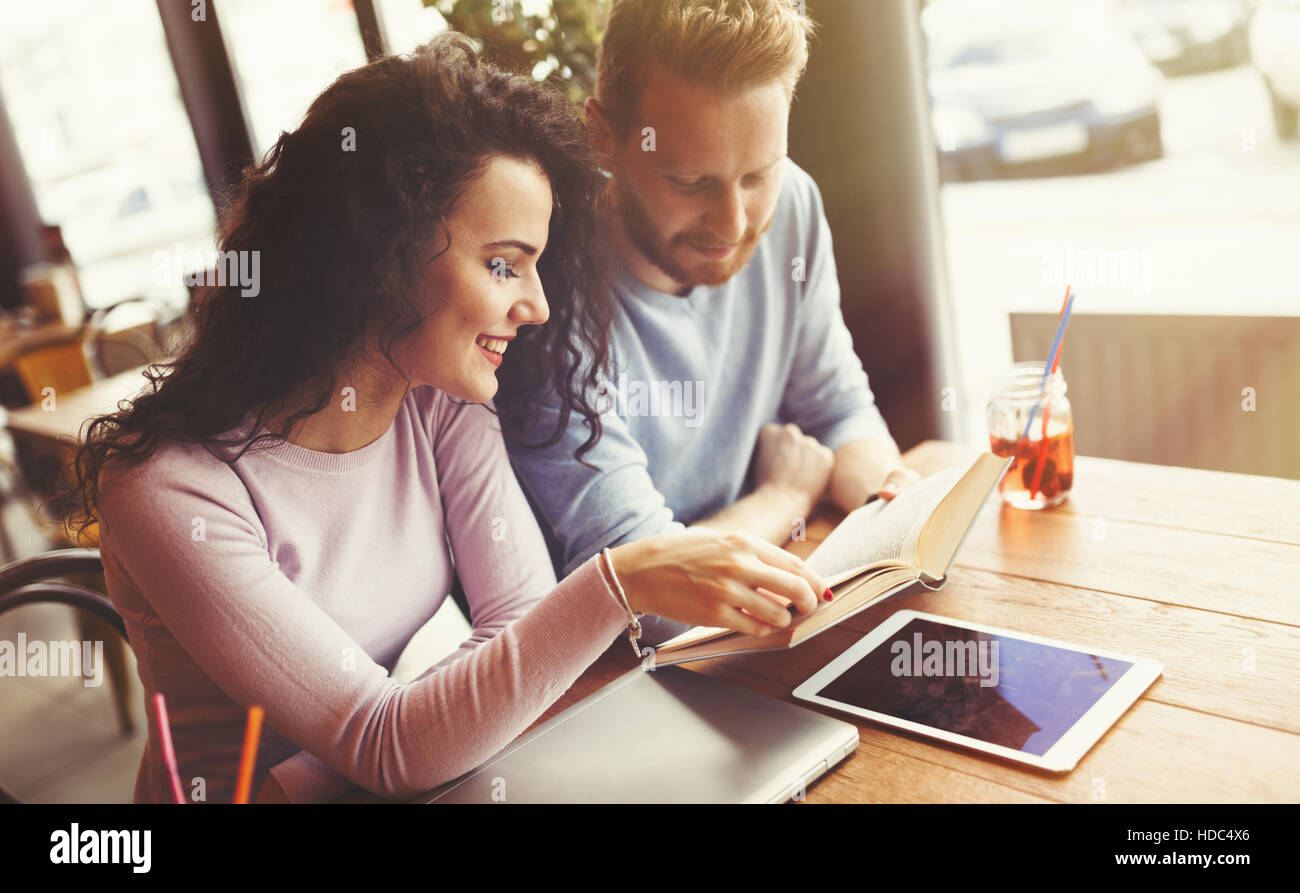 Happy couple studying in library for university exam Stock Photo - Alamy
