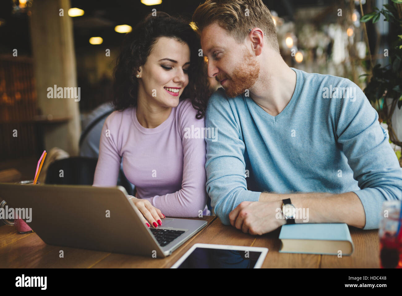 Happy couple studying in library for university exam Stock Photo - Alamy