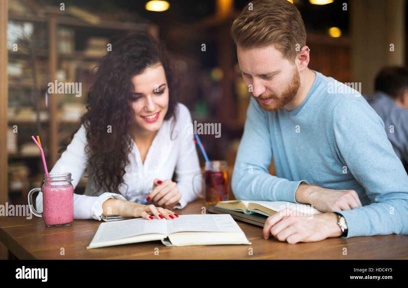 Happy couple studying in library for university exam Stock Photo - Alamy
