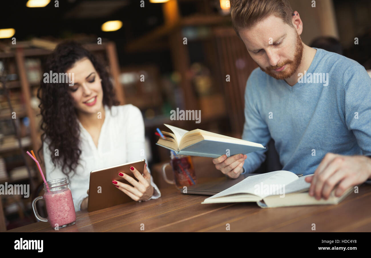 Happy couple studying in library for university exam Stock Photo - Alamy