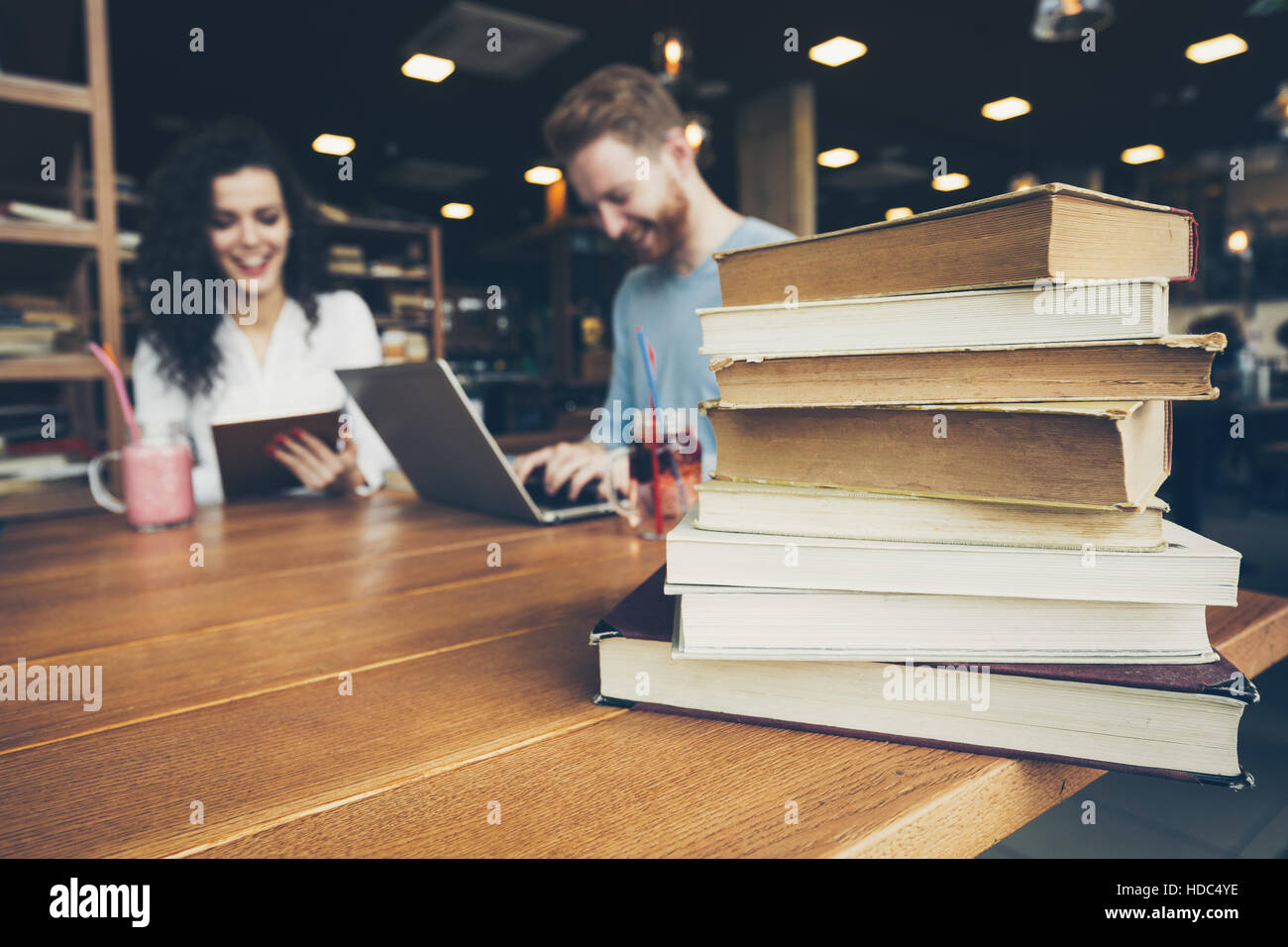 Happy couple studying in library for university exam Stock Photo - Alamy