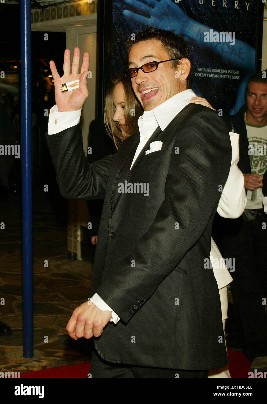 Actor Robert Downey, Jr. waves to photographers while arriving at the ...