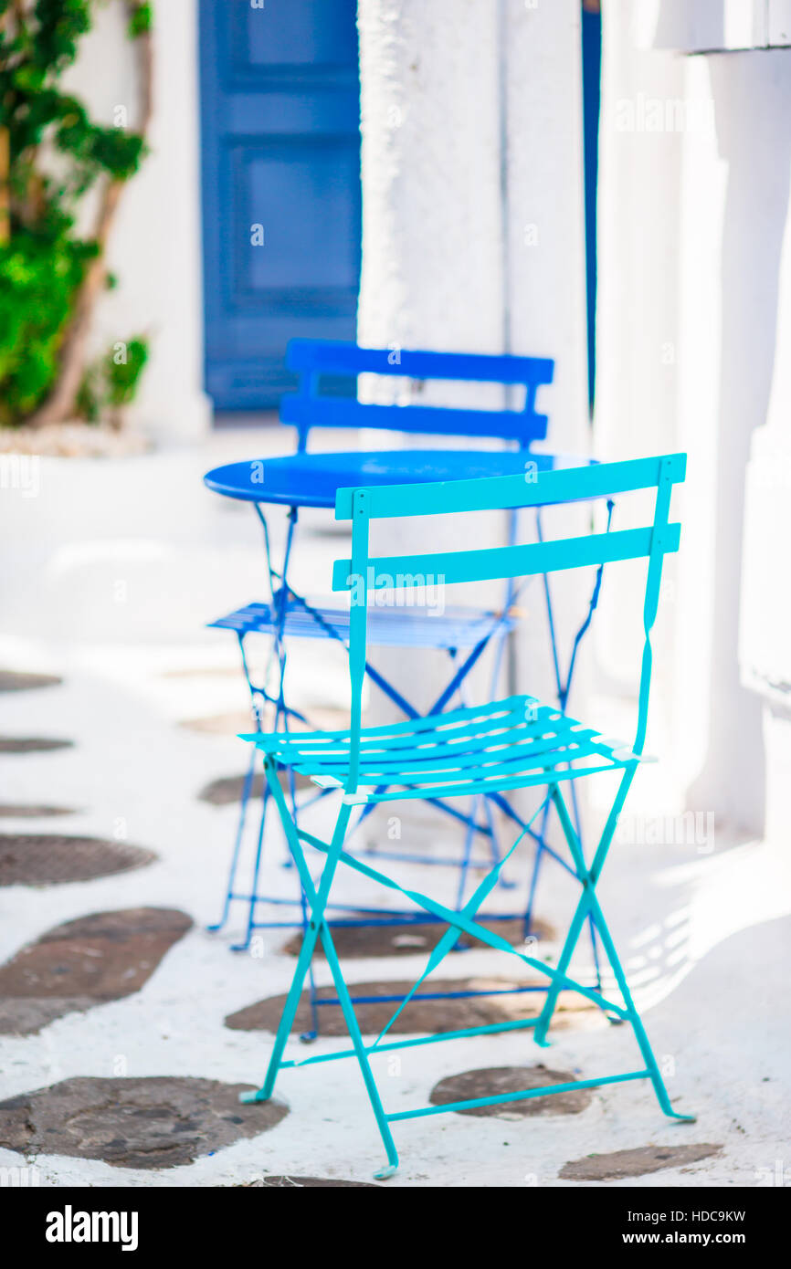 Two blue chairs on a street of typical greek traditional village on ...