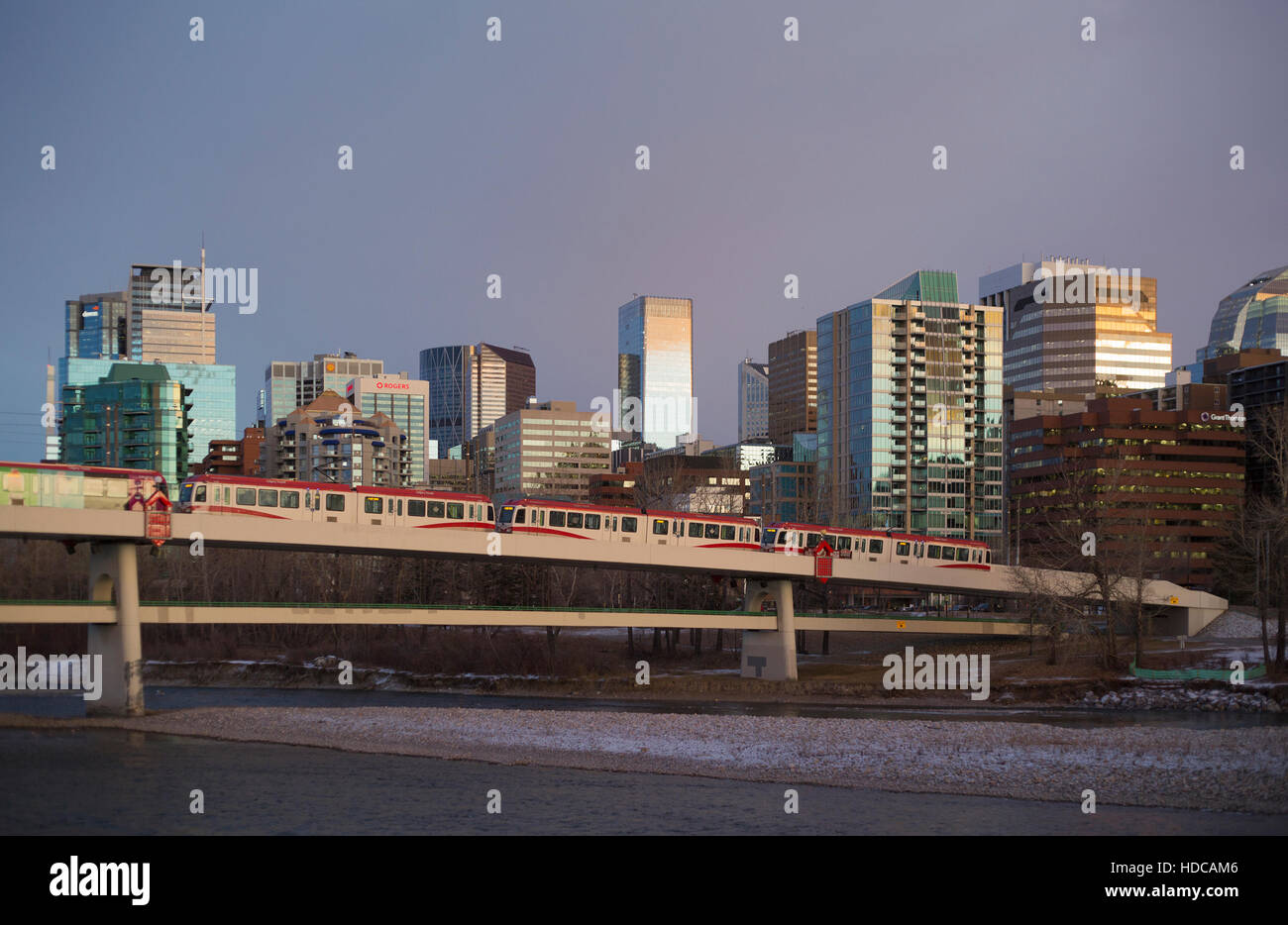 Light rail electric train powered by wind energy crossing Bow River to ...