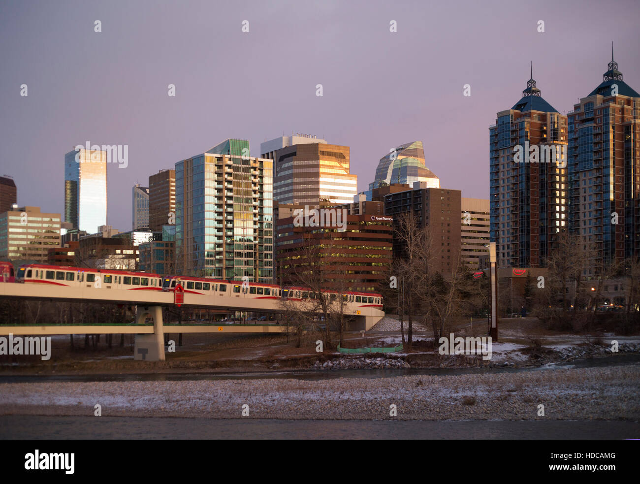 Light rail electric train powered by wind energy crossing Bow River ...