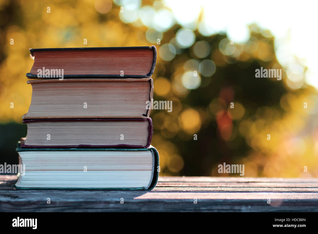 autumn book stack wooden outdoor Stock Photo - Alamy