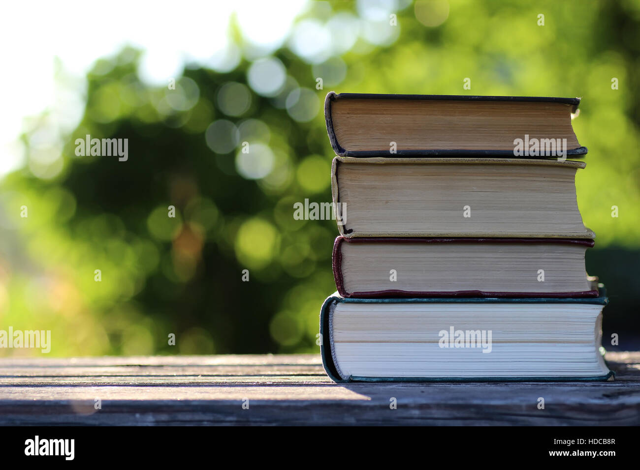 book stack background table wooden outdoor Stock Photo - Alamy