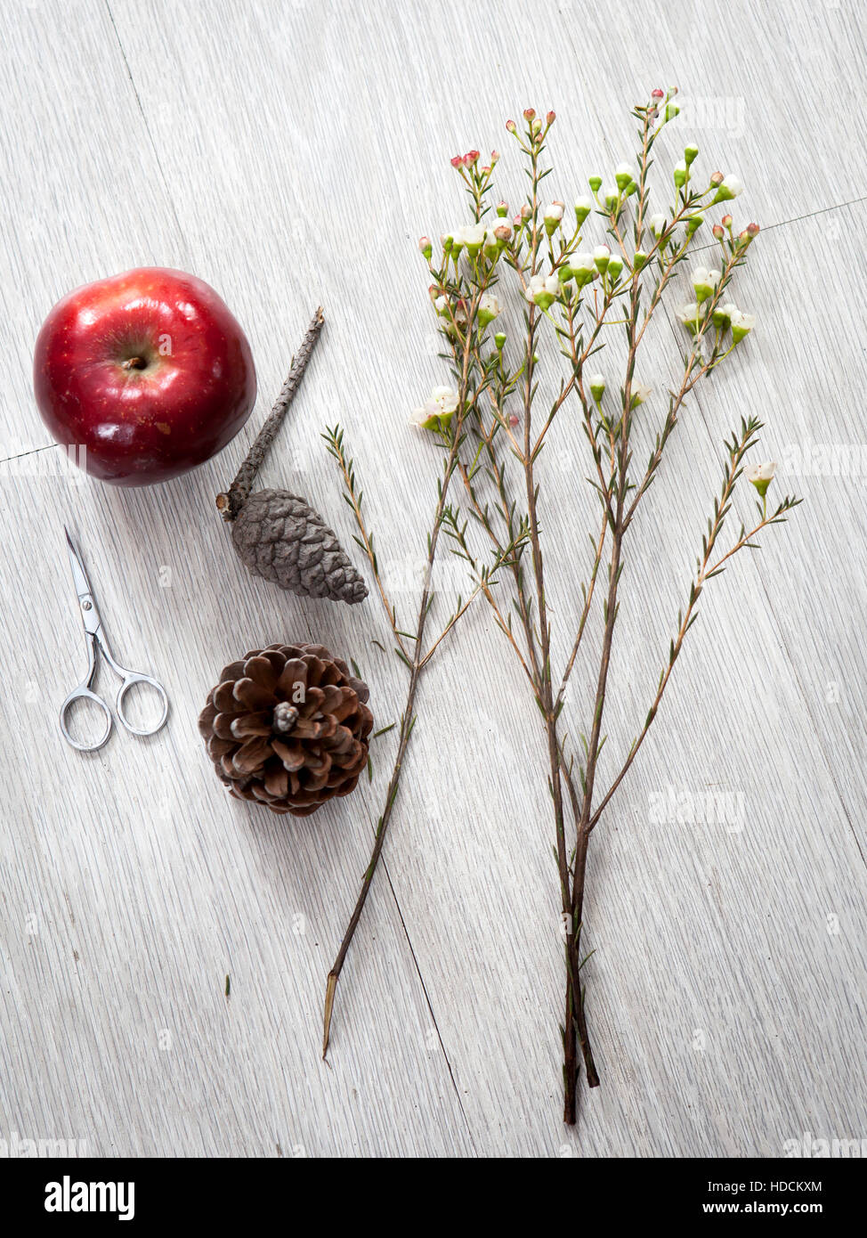 Apple and tangerine with cone at the table for present Stock Photo - Alamy