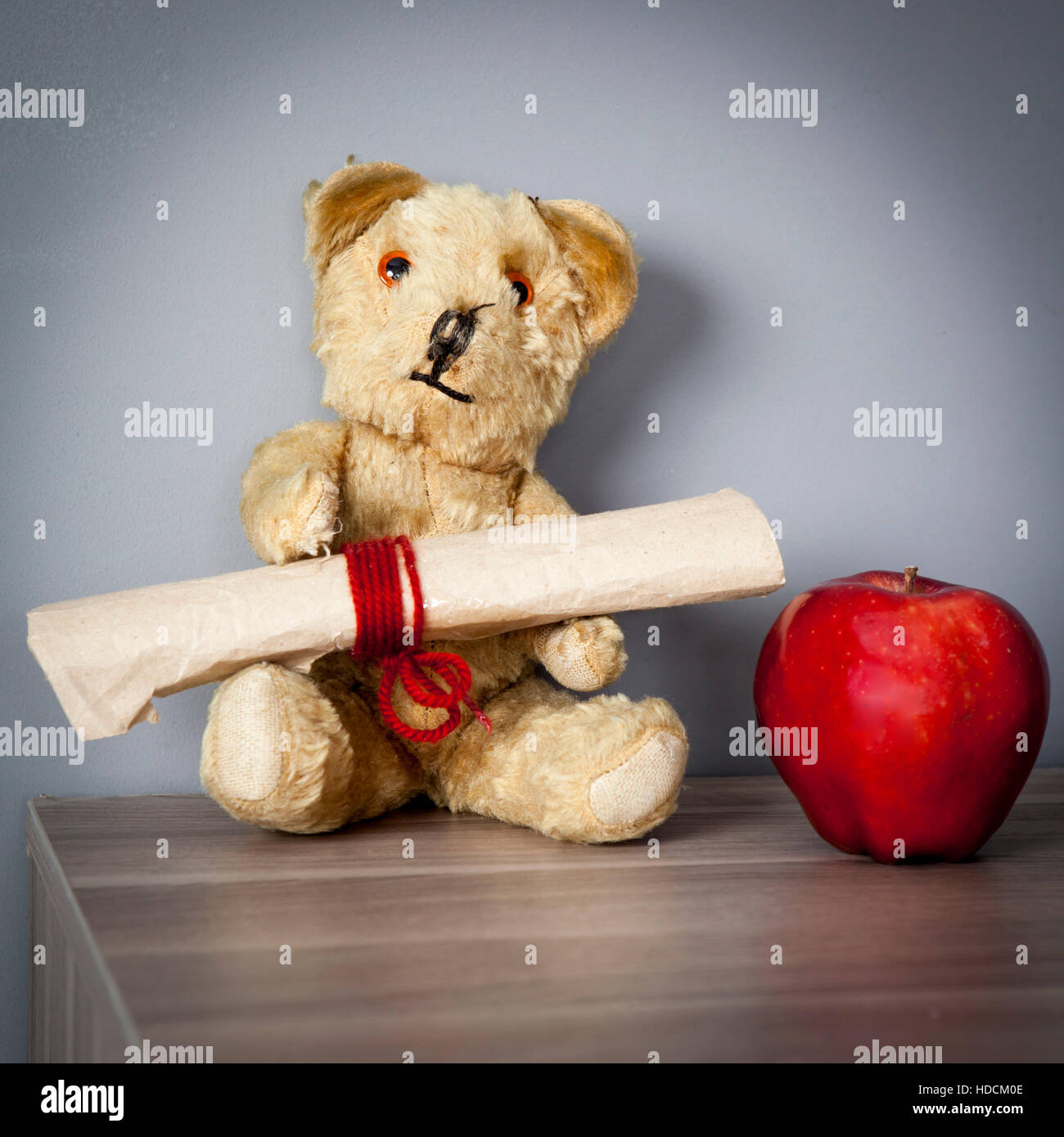 Old vintage teddy-bear with apple sitting on the capboard Stock Photo ...