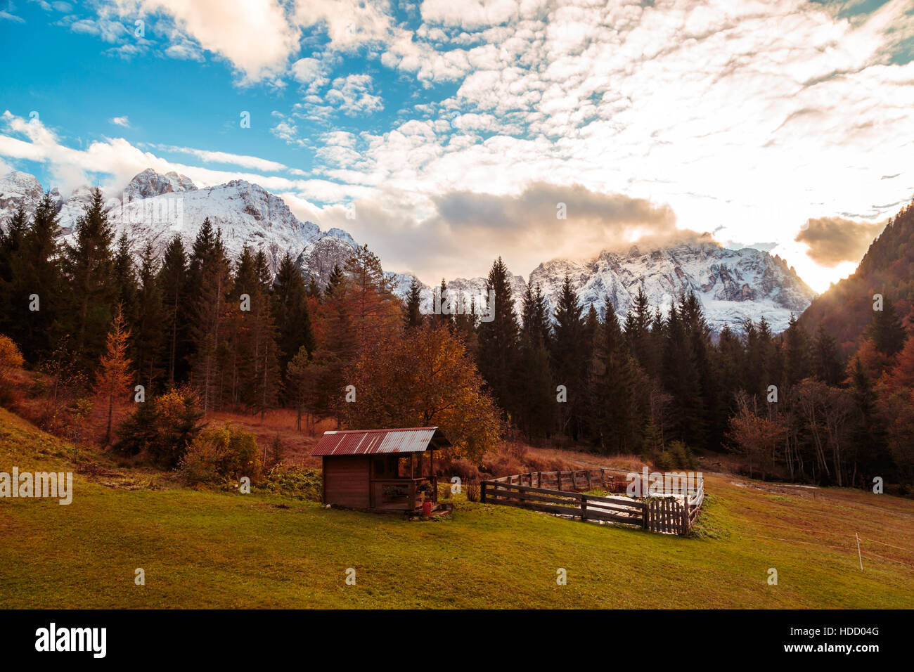 an alpine hut in the valley during a colorful sunset Stock Photo - Alamy