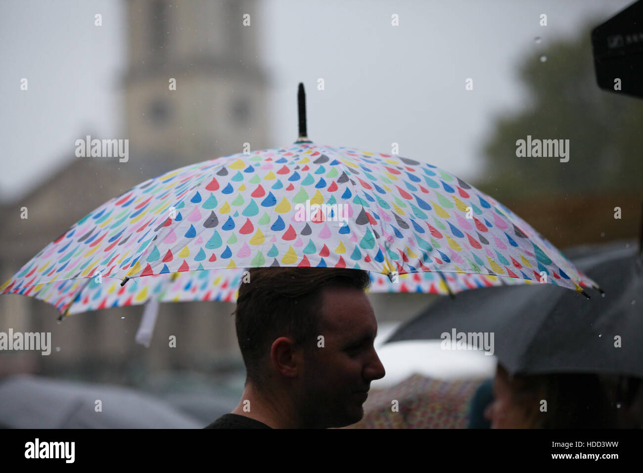 People in heavy rain and windy conditions in Trafalgar Square, London ...