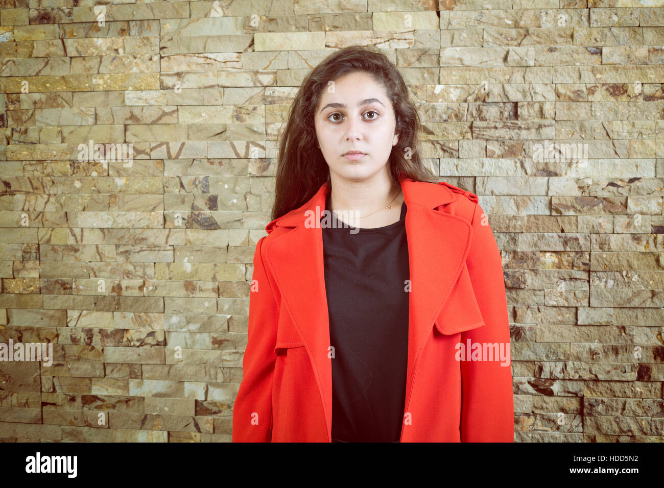 Serious teenage girl wearing a red jacket Stock Photo - Alamy