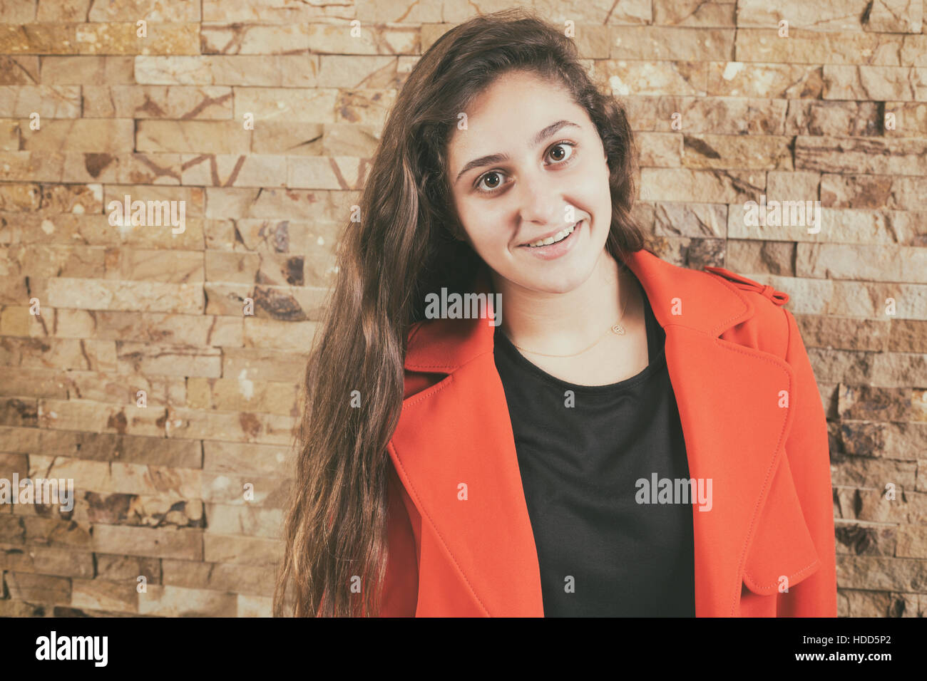 Happy teenage girl wearing a red jacket smiling Stock Photo - Alamy