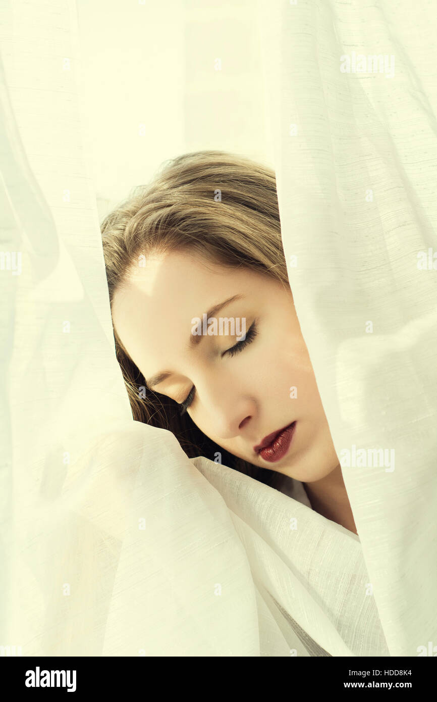 Beautiful woman eyes closed by the window Stock Photo - Alamy
