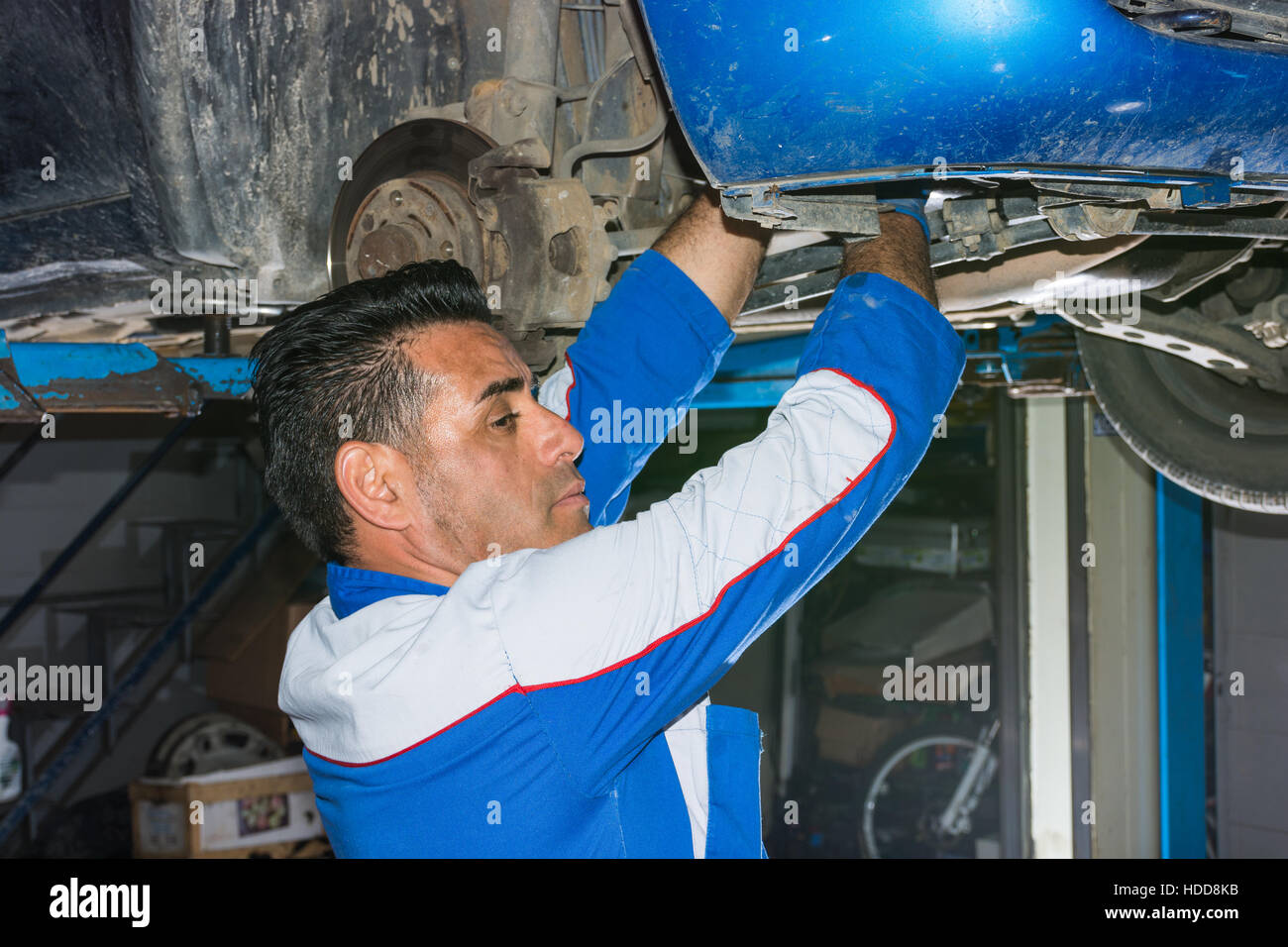 Car mechanic fixing an engine in his garage. copy space Stock Photo - Alamy
