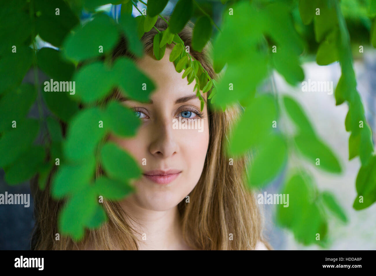 Female peeking through leaves hi-res stock photography and images - Alamy