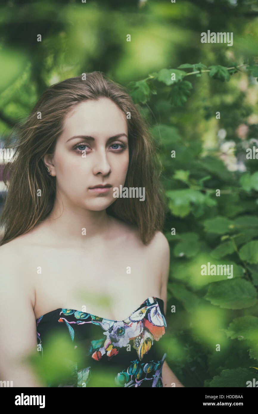 Sad young woman standing outdoors Stock Photo - Alamy