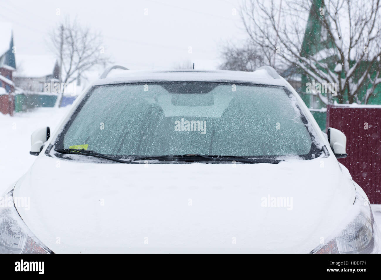 White car covered with snow during a blizzard Stock Photo - Alamy