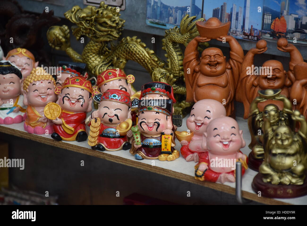 Souvenirs of smiling Buddha and other chinese characters in a market ...