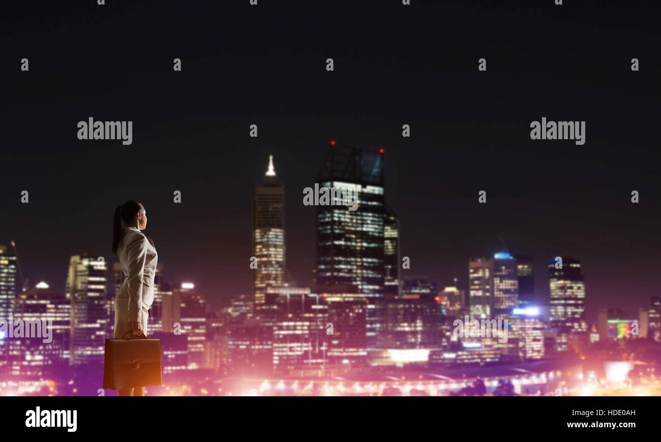 Woman looking at night city Stock Photo - Alamy