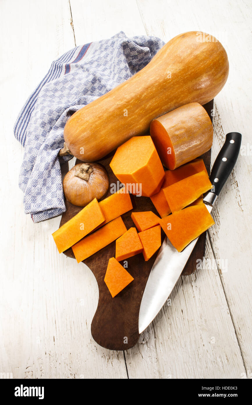 peeled butternut pumpkin on a wooden board Stock Photo - Alamy