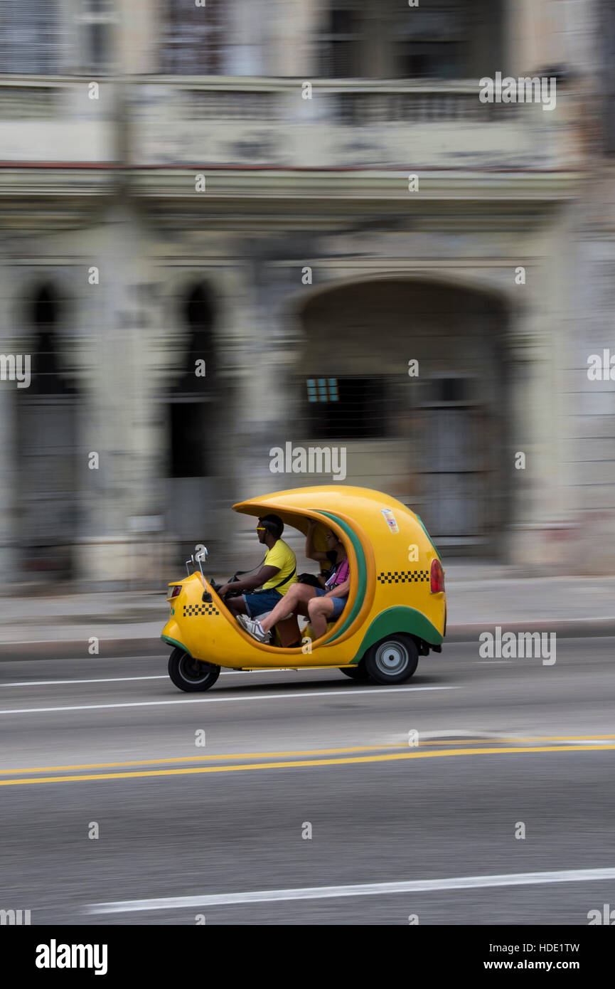 Yellow Cocotaxi 3 Wheel Scooter Taxion driving on the Malecon, Havana ...