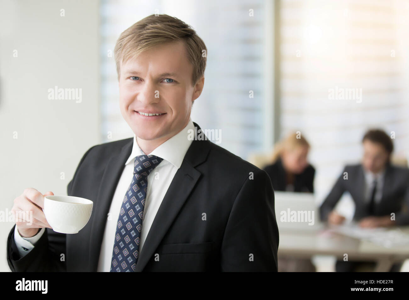 Young smiling businessman Stock Photo - Alamy