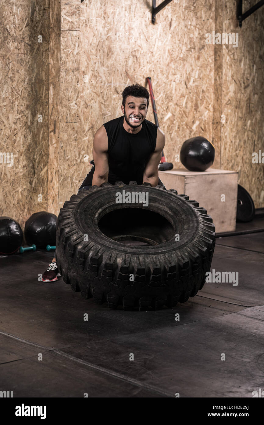 Sport Fitness Man Flipping Wheel Tire Crossfit Training, Young Healthy ...