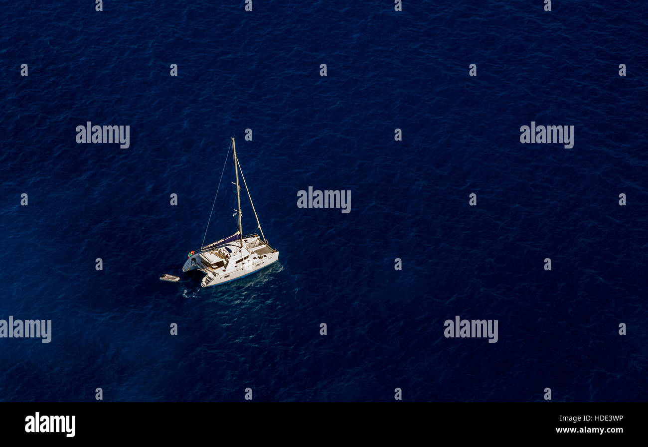 A catamaran on the deep blue seas of Capri, Campania, Italy Stock Photo ...