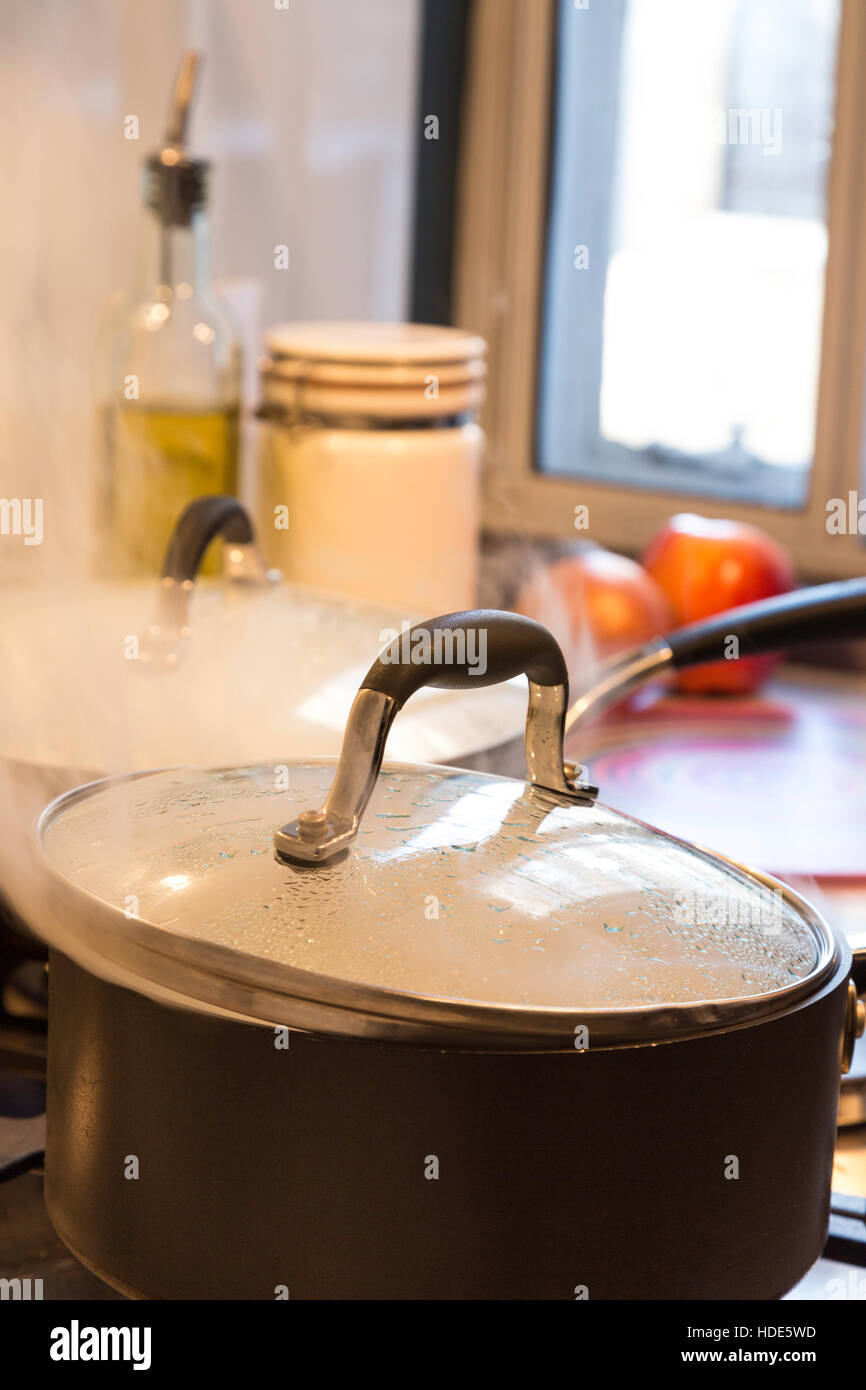 Steaming Pots on Residential Stovetop Stock Photo - Alamy