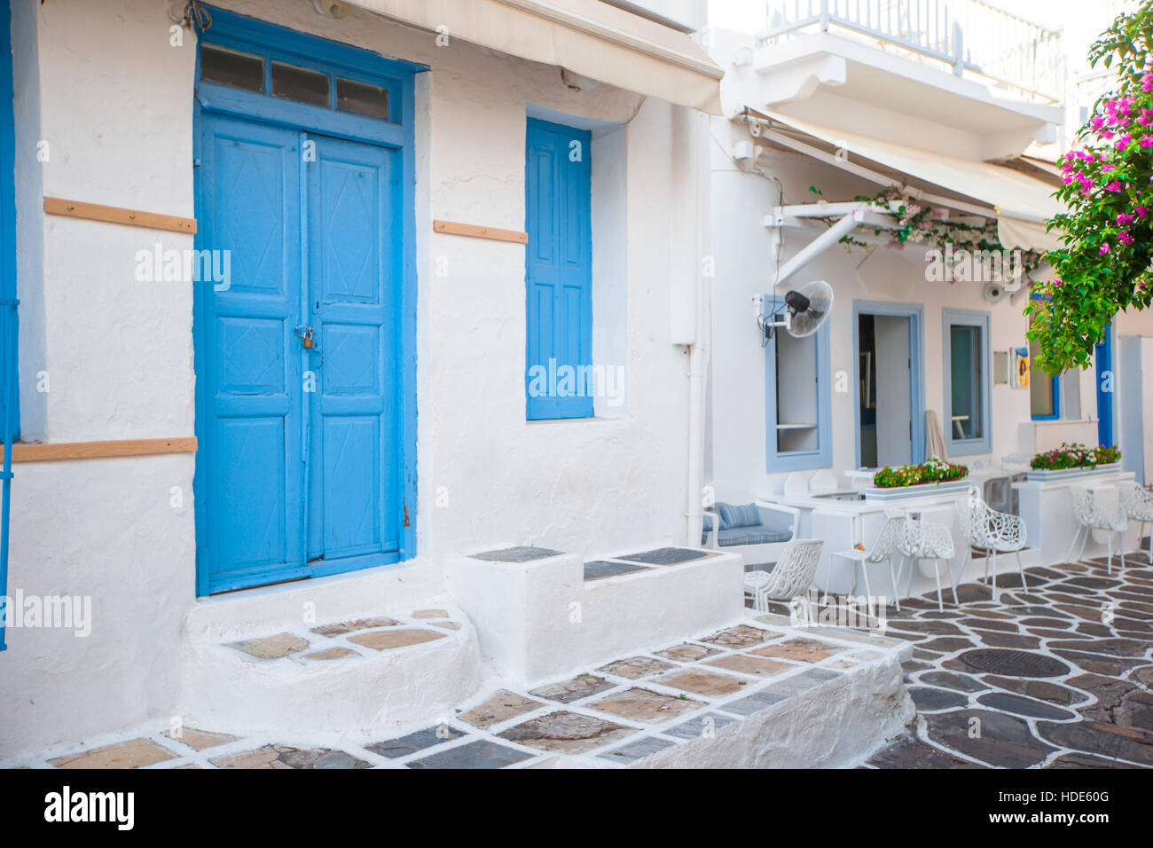 The narrow streets of the island with blue balconies, stairs and ...