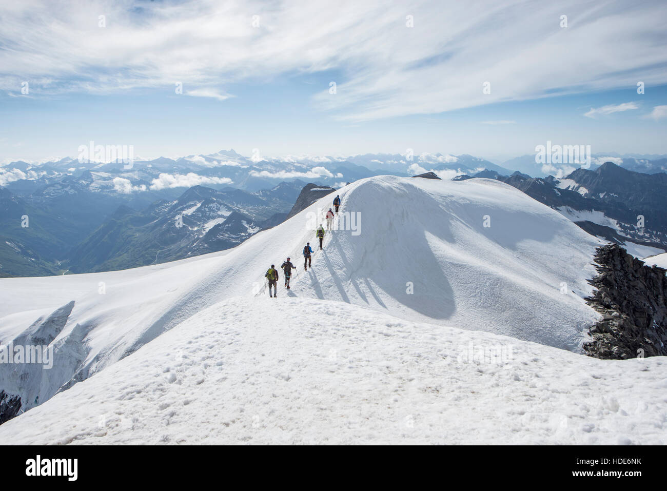 Group of climbers roped together climbing the snowy slope of the ...