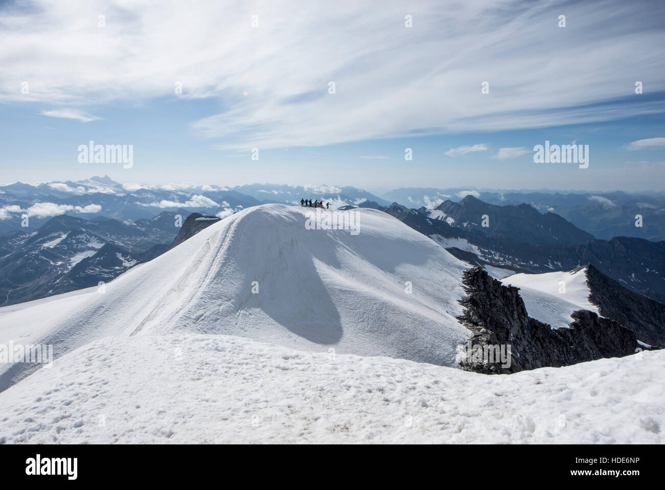 Group of climbers roped together climbing the snowy slope of the ...