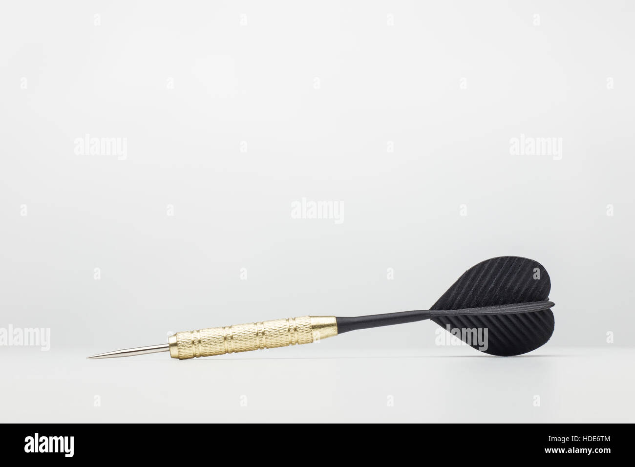 single dart on white shot in the studio Stock Photo - Alamy