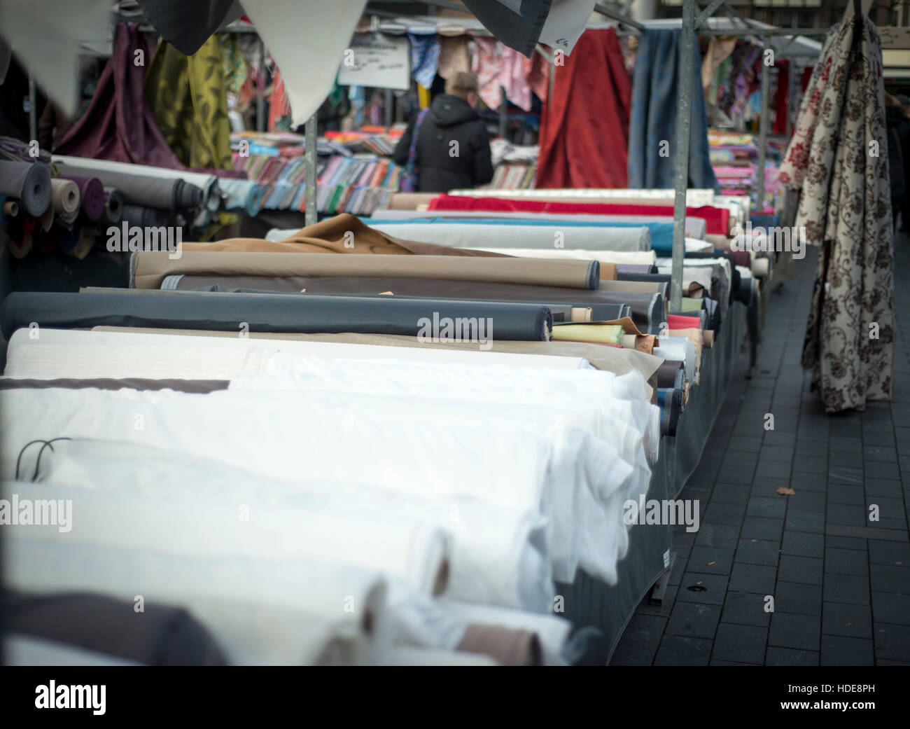 Many colored textiles exposed for sale in an traditional textile market ...