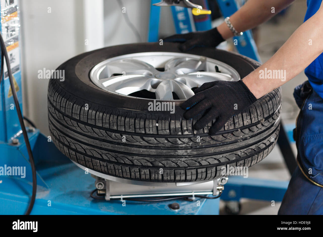 Mechanic removes car tire closeup. Machine for removing rubber from the ...