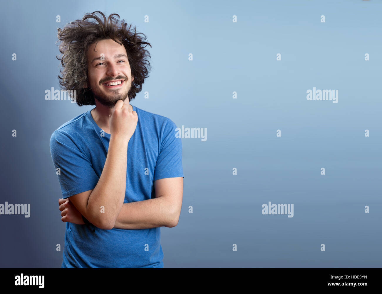 Beautiful man in front of a colored background Stock Photo - Alamy