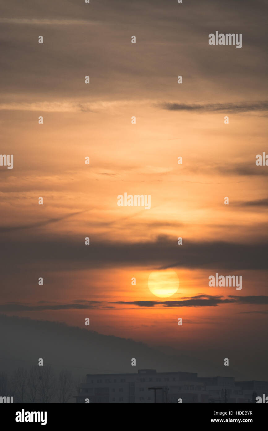 Orange sunset over the city Stock Photo - Alamy