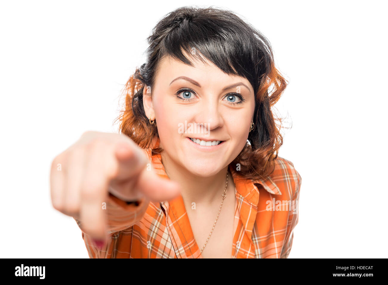 Positive beautiful woman shows a finger at the camera on a white ...