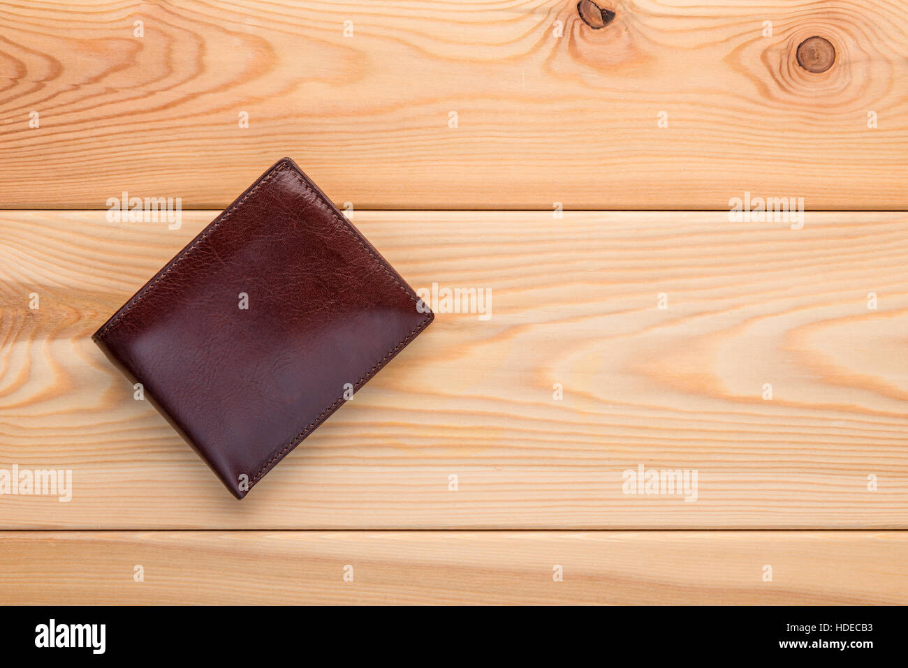 men's classic wallet brown color on the wooden floor closeup Stock ...
